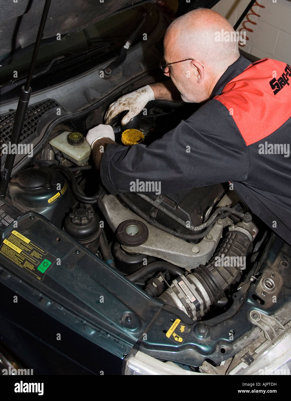 A car mechanic at work on a car engine Stock Photo - Alamy