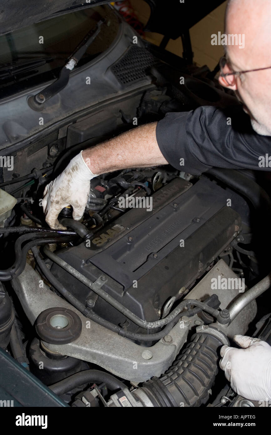 A car mechanic at work on a car engine Stock Photo - Alamy
