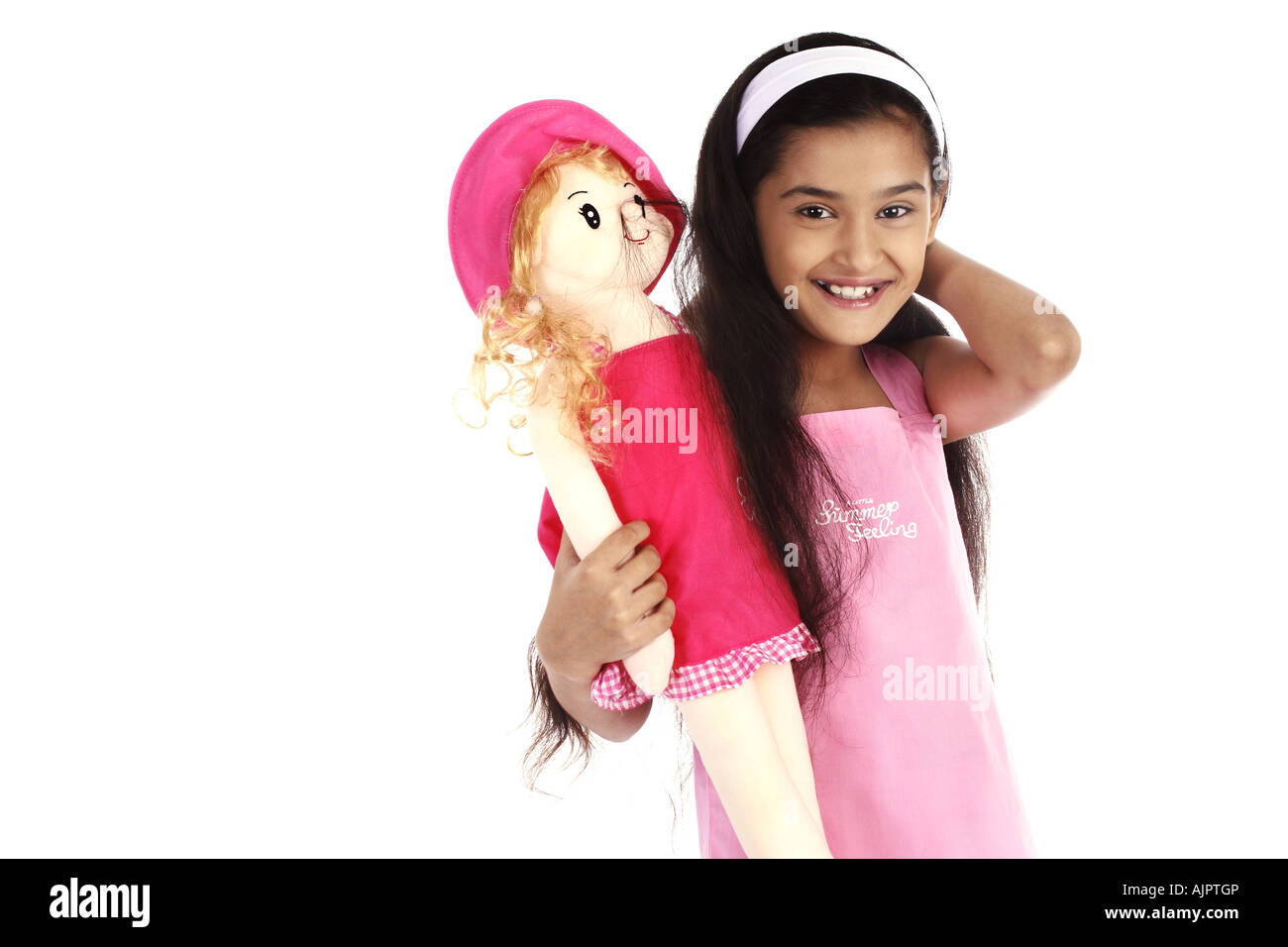 A young girl holding a doll Stock Photo - Alamy