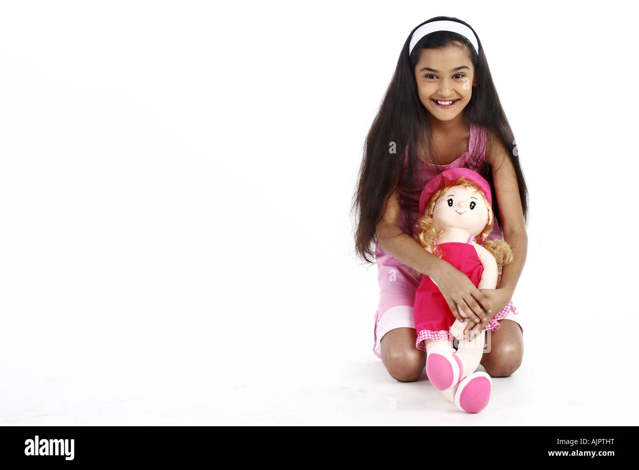 A young girl holding a doll Stock Photo - Alamy A young girl holding a doll Stock Photo - Alamy