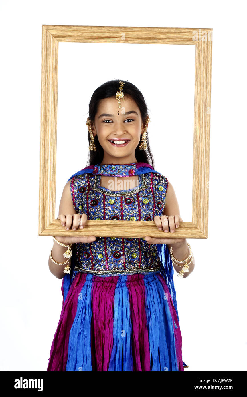 Portrait of a girl in traditional clothes holding a frame Stock Photo ...