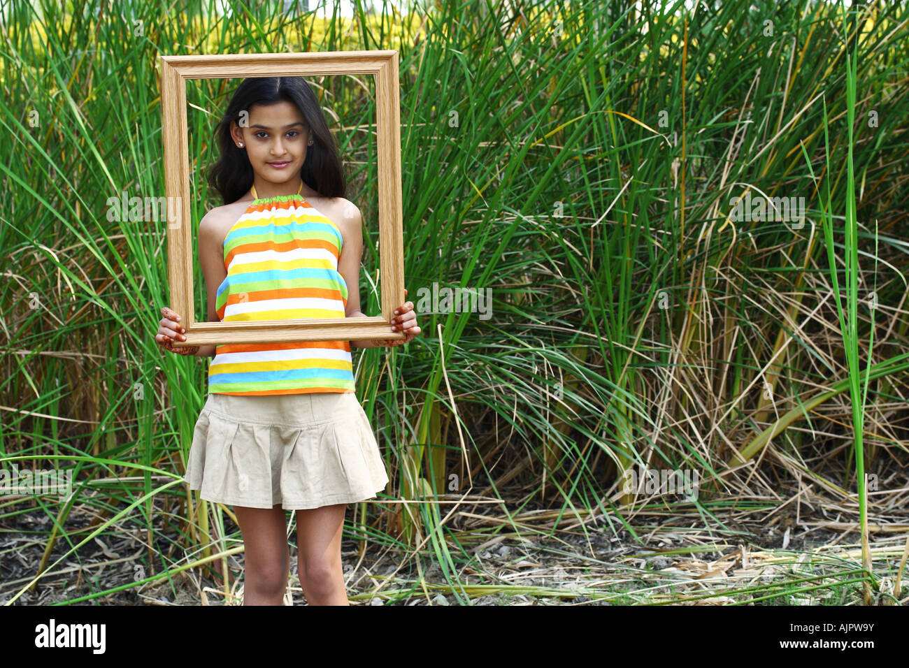 Portrait of a girl holding a frame Stock Photo - Alamy