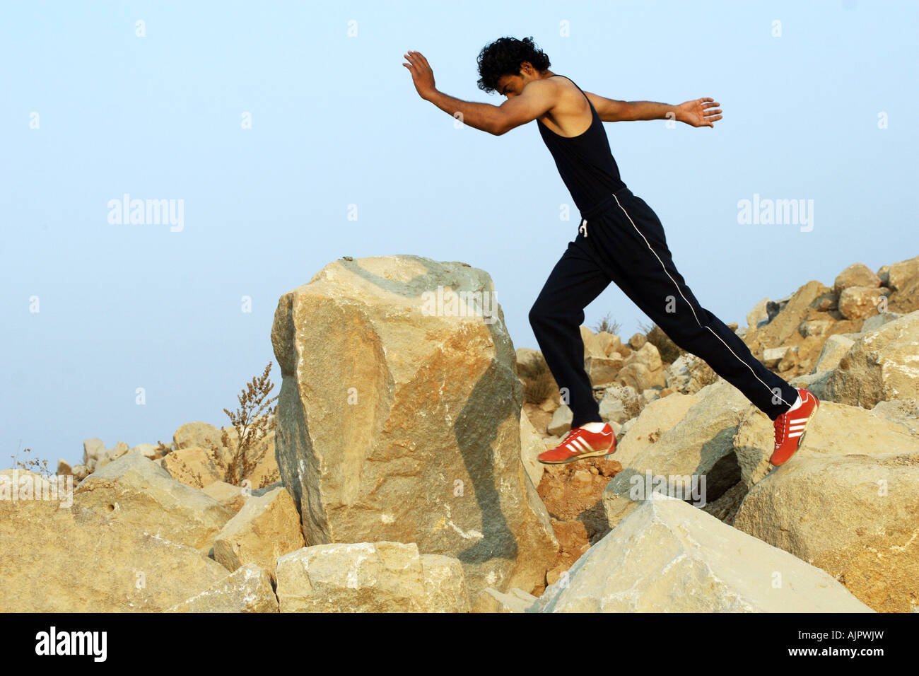 A man running on rocks Stock Photo - Alamy