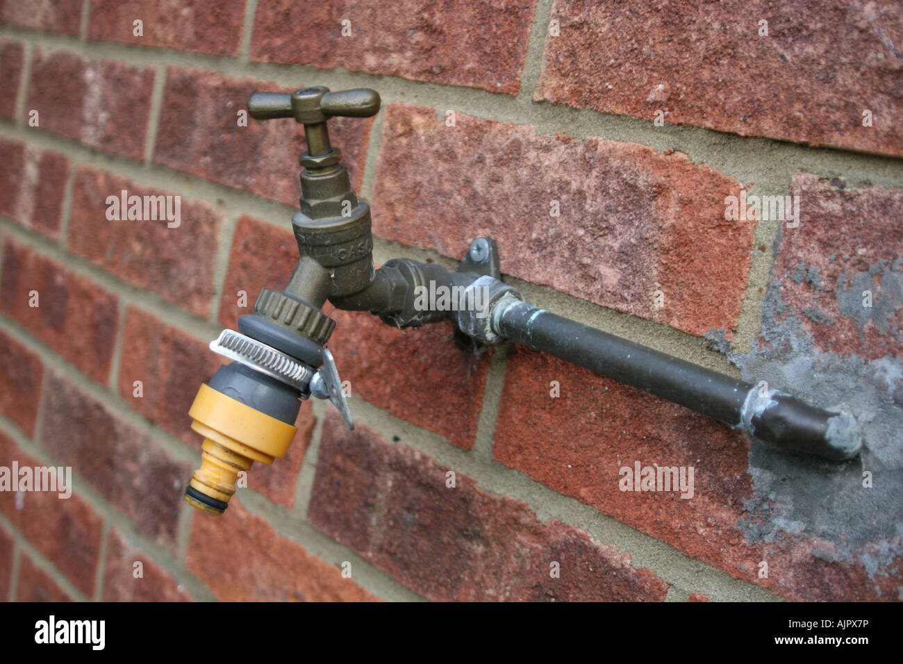 outside tap on brick wall Stock Photo - Alamy