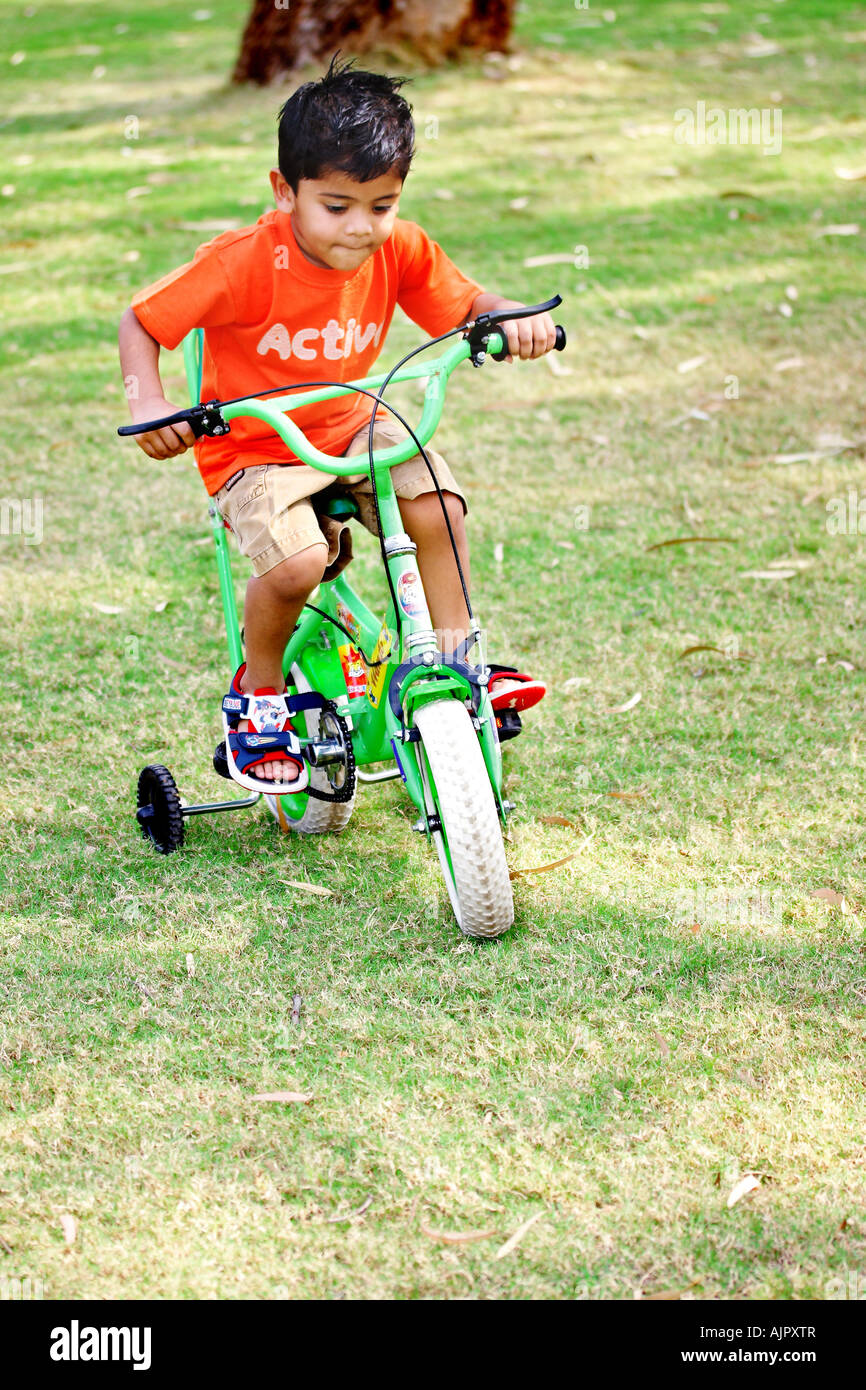 A young kid riding his cycle Stock Photo - Alamy