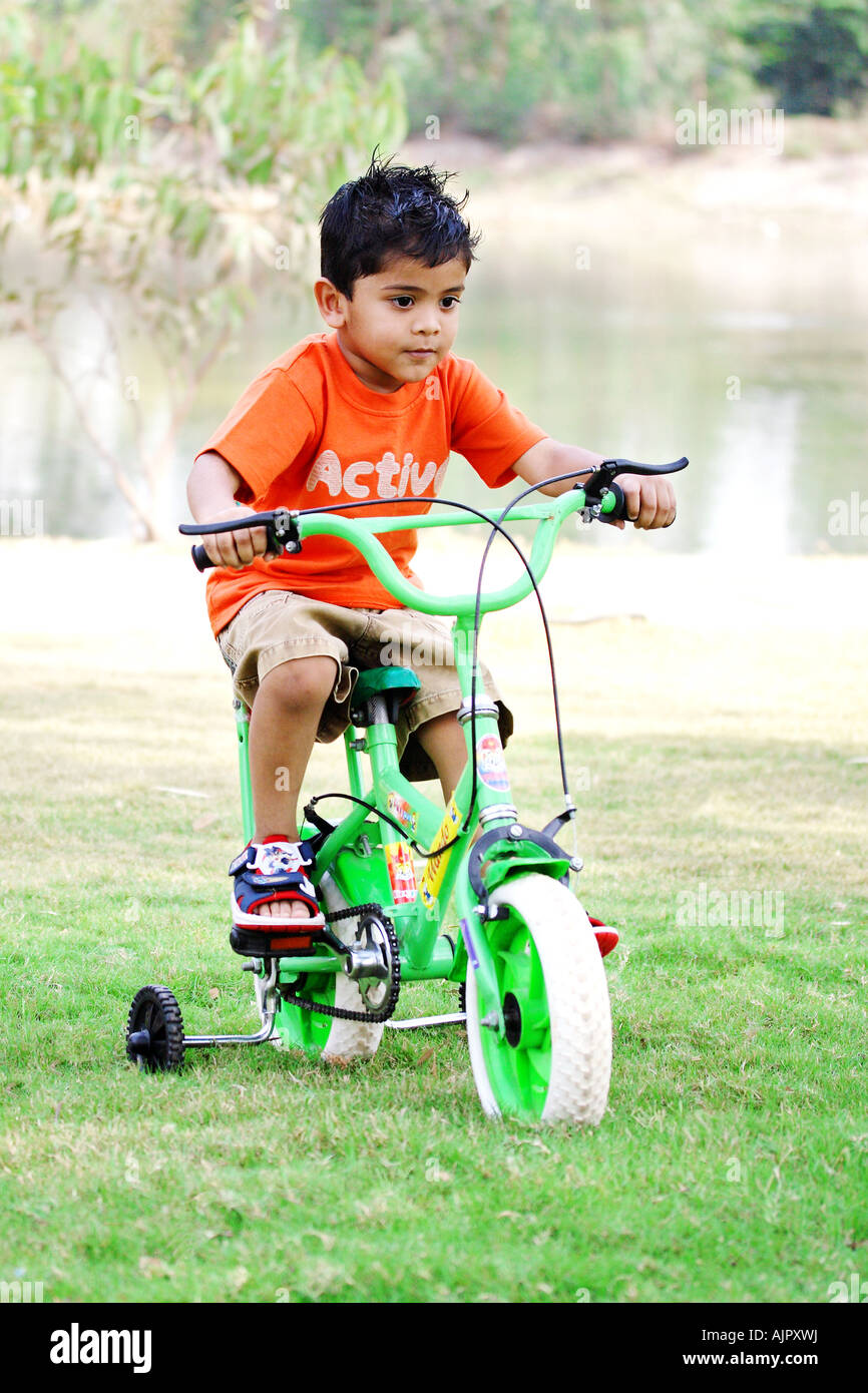 A young kid riding his cycle Stock Photo - Alamy