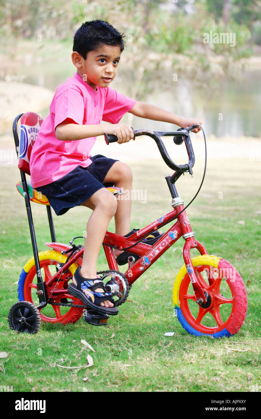 A young kid riding his cycle Stock Photo - Alamy