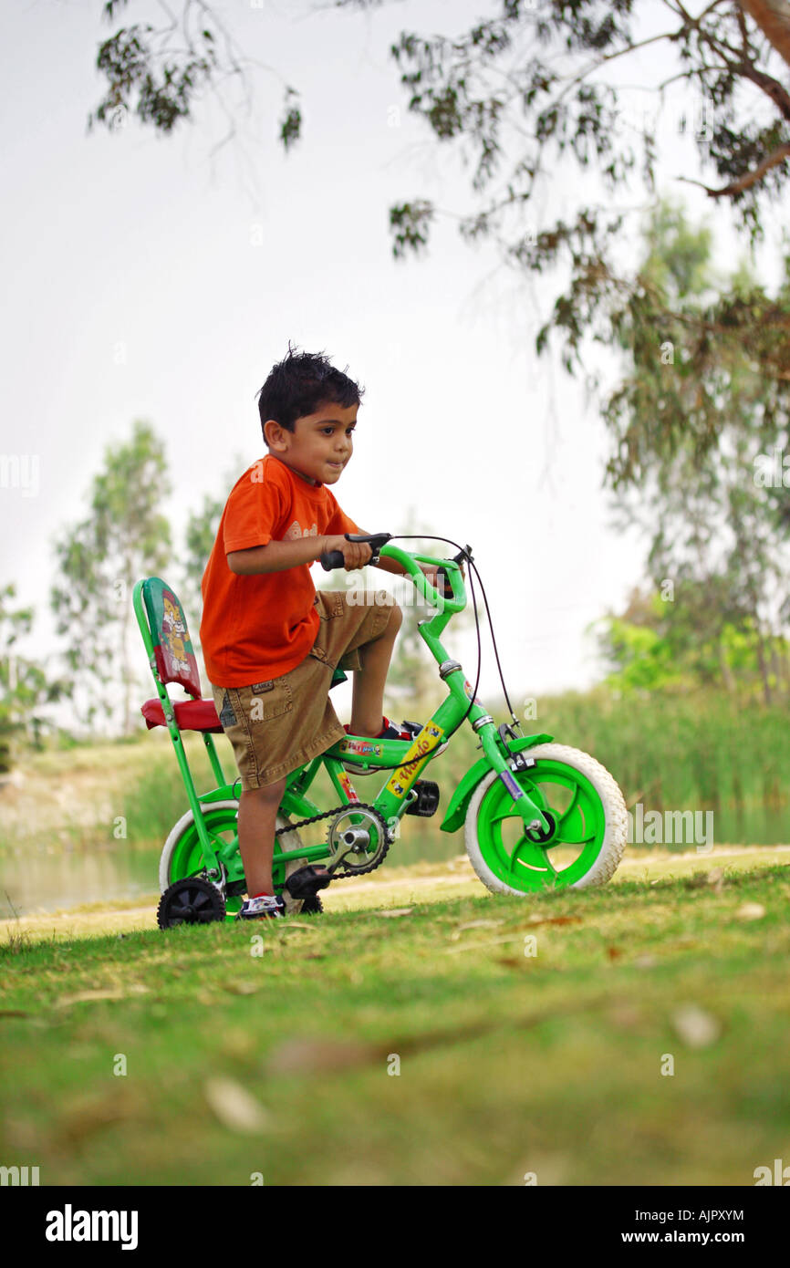 A young kid riding his cycle Stock Photo - Alamy