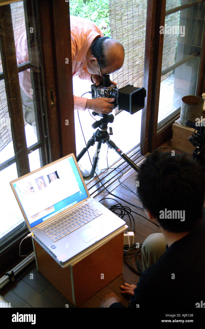 Japanese photographer using a Hassleblad medium format camera tied to ...
