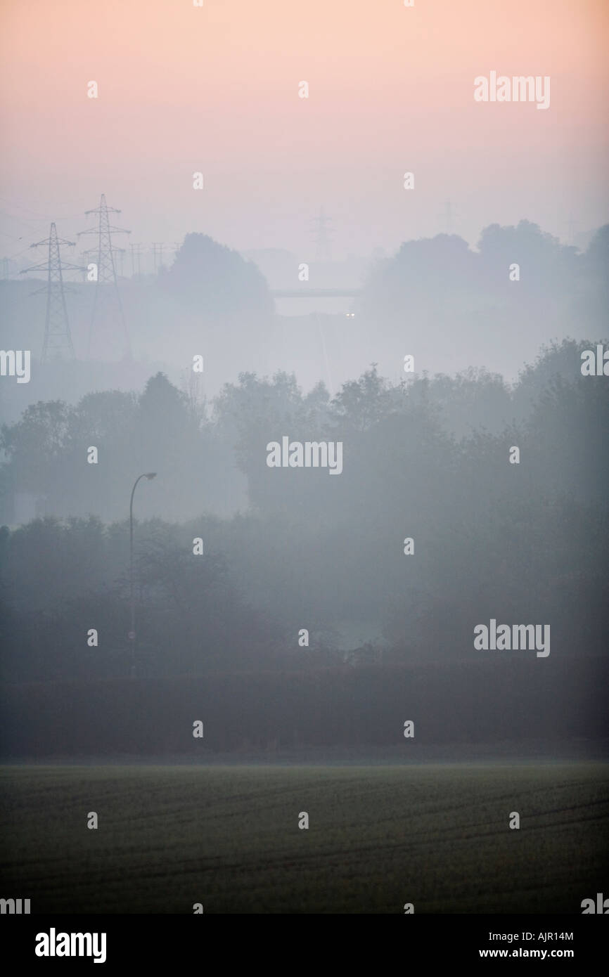 Countryside road pylon field Stock Photo - Alamy