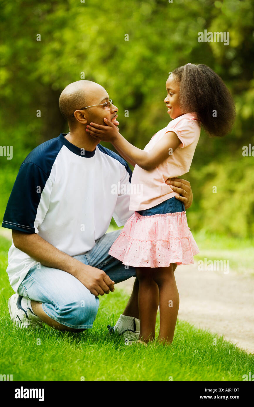 Side view of father with daughter in park Stock Photo - Alamy