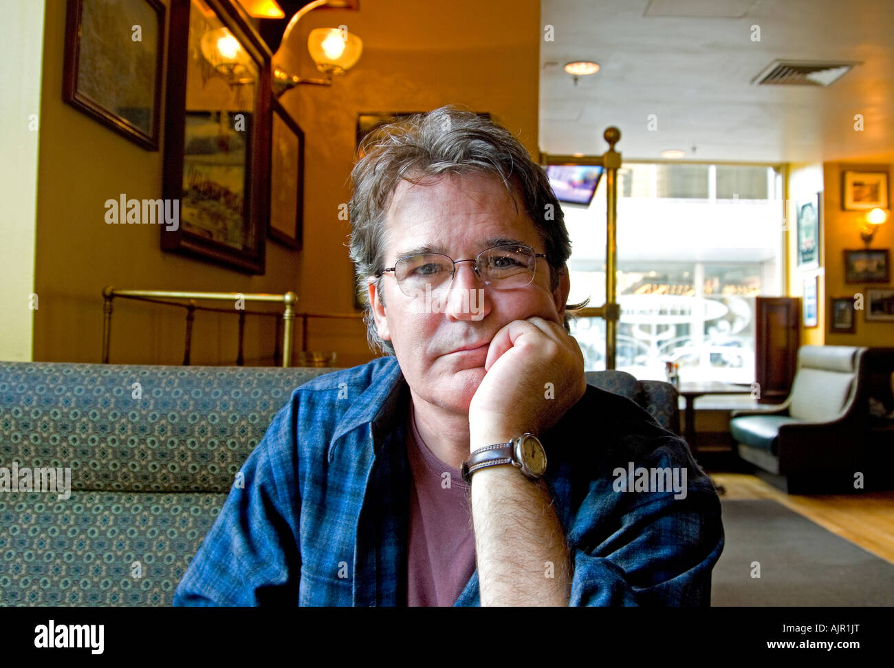 Portrait of man sitting in booth Stock Photo - Alamy