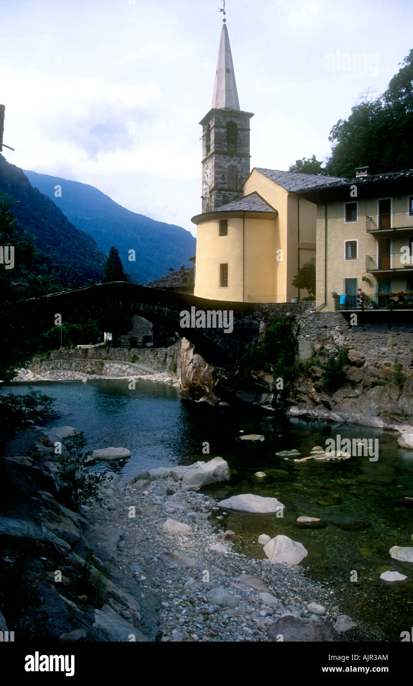 Icy river flowing past church and bridge of Fontainemore Stock Photo ...