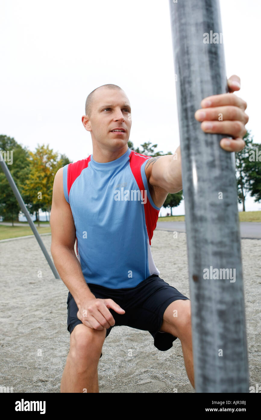 fit muscular hard body male personal trainer exercising with a ball ...