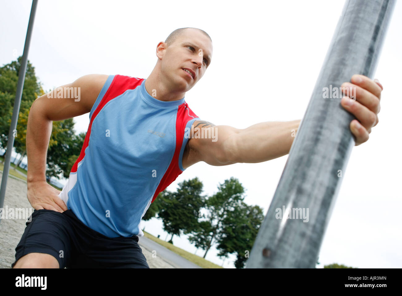 fit muscular hard body male personal trainer exercising with a ball ...