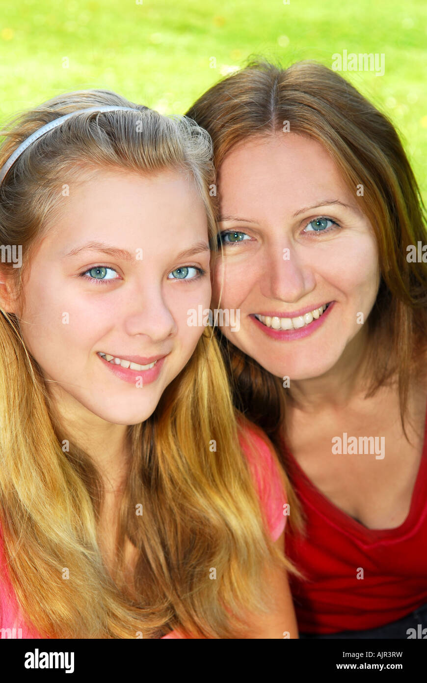 Portrait of smiling mother and daughter in summer park Stock Photo - Alamy