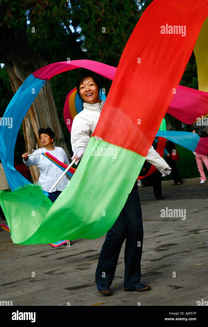 Woman doing morning exercise with ribbon at the Temple of Heaven ...