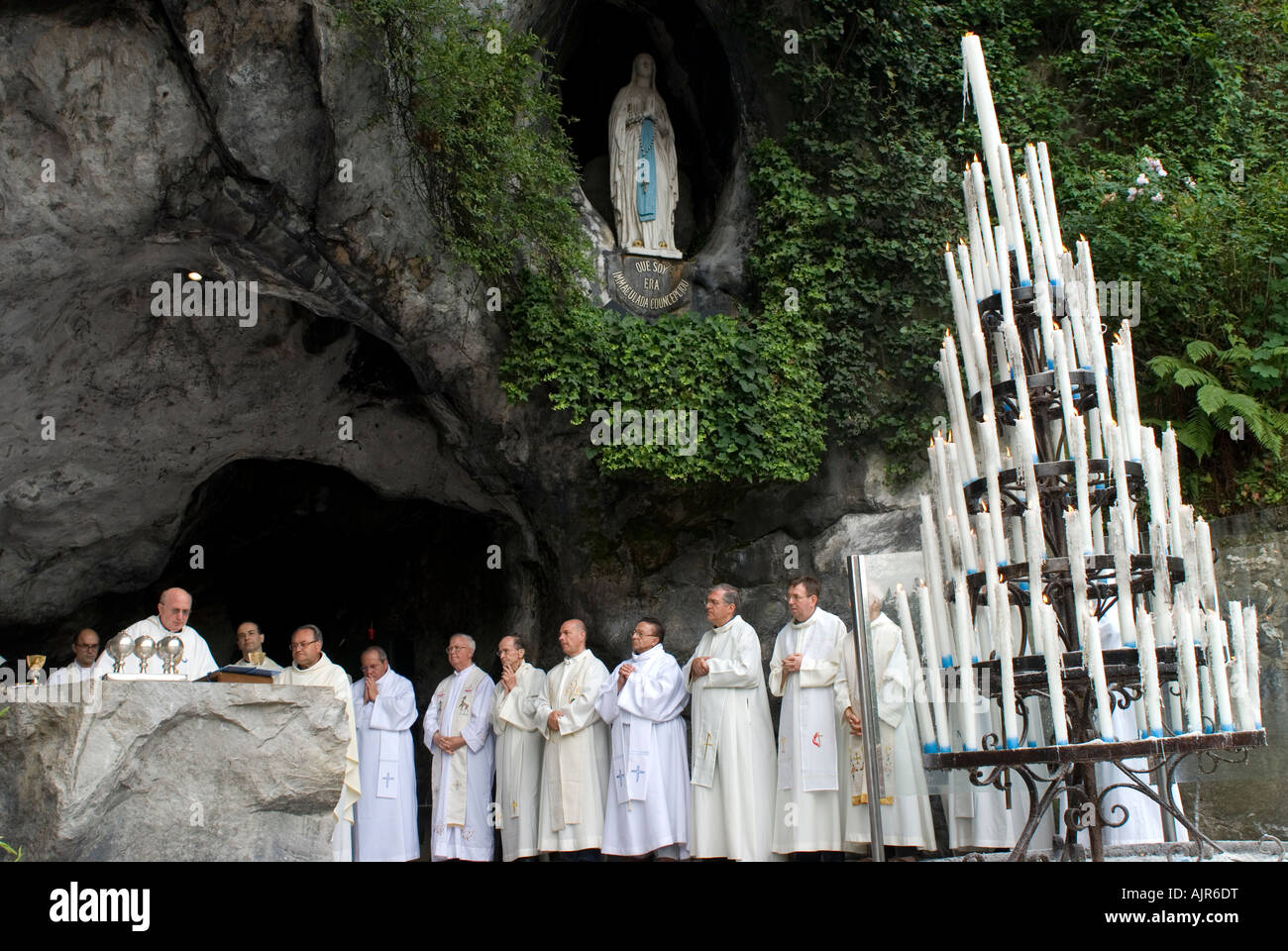 Blessings given by priest in front of Grotto, Statue of Maria and ...
