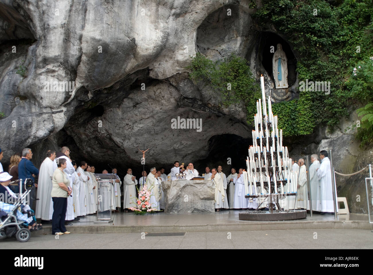 Blessings given by priest in front of Grotto Stock Photo - Alamy