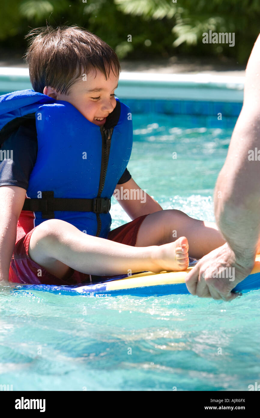 boy playing with his dad in a swimming pool Stock Photo - Alamy