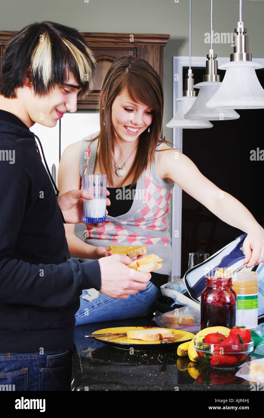 Siblings making lunch together Stock Photo - Alamy