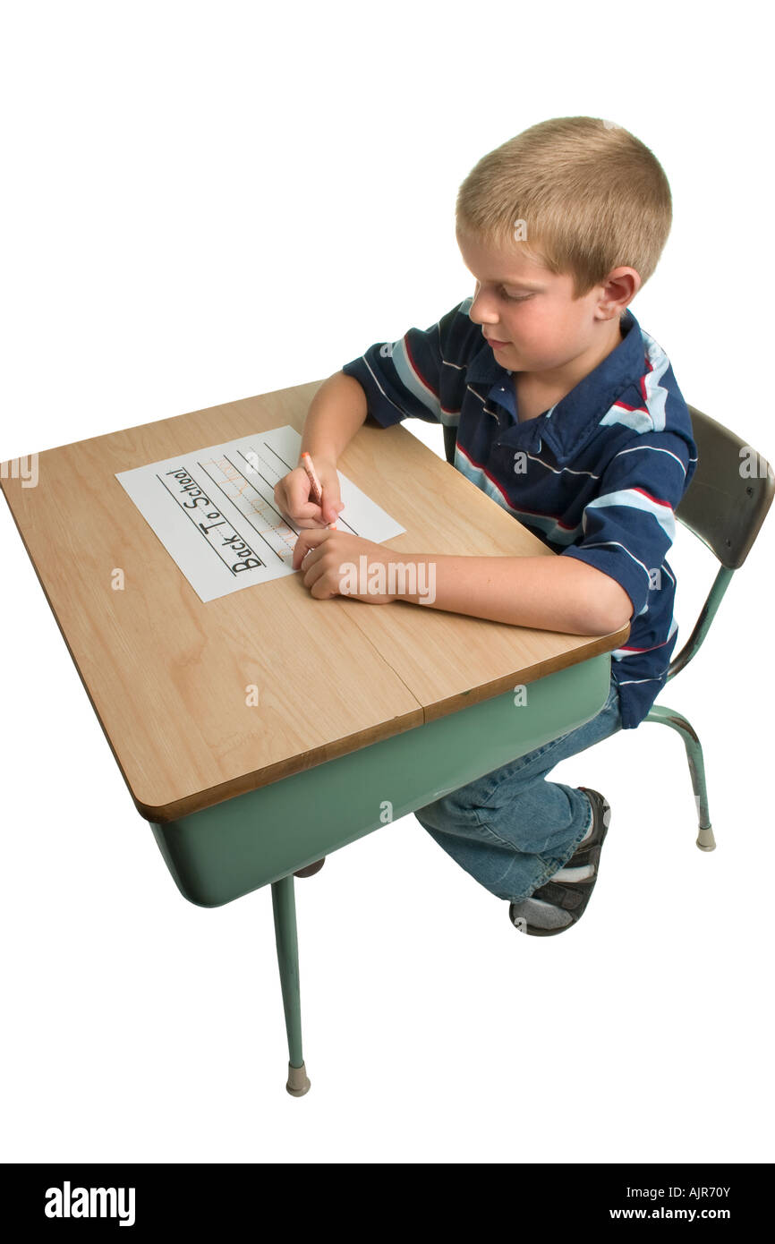 boy writing back to school on school desk isolated on white background ...