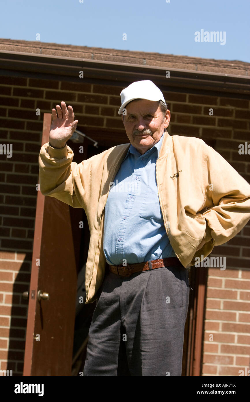 old man waving and smiling outside wearing a jacket Stock Photo - Alamy