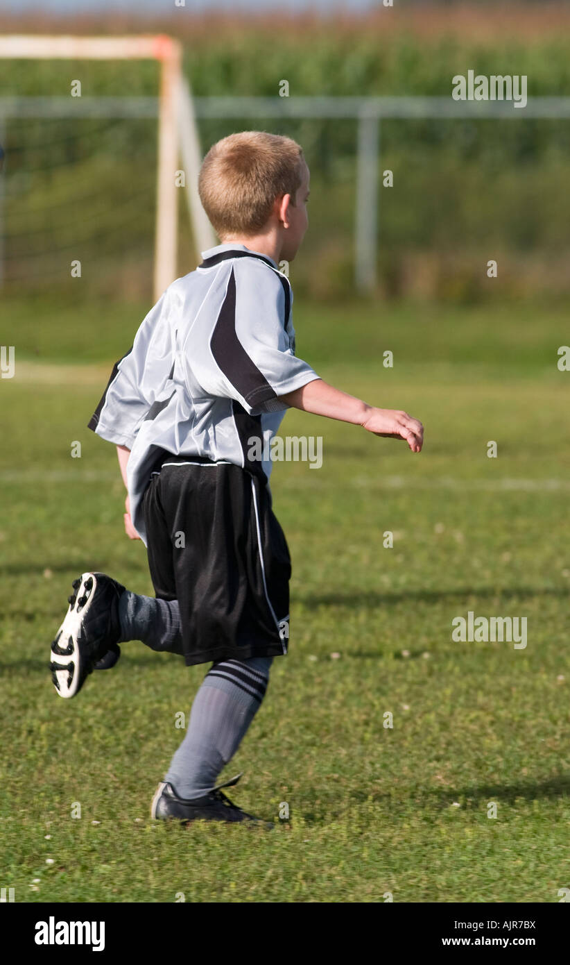 young soccer player running on the soccer field Stock Photo - Alamy