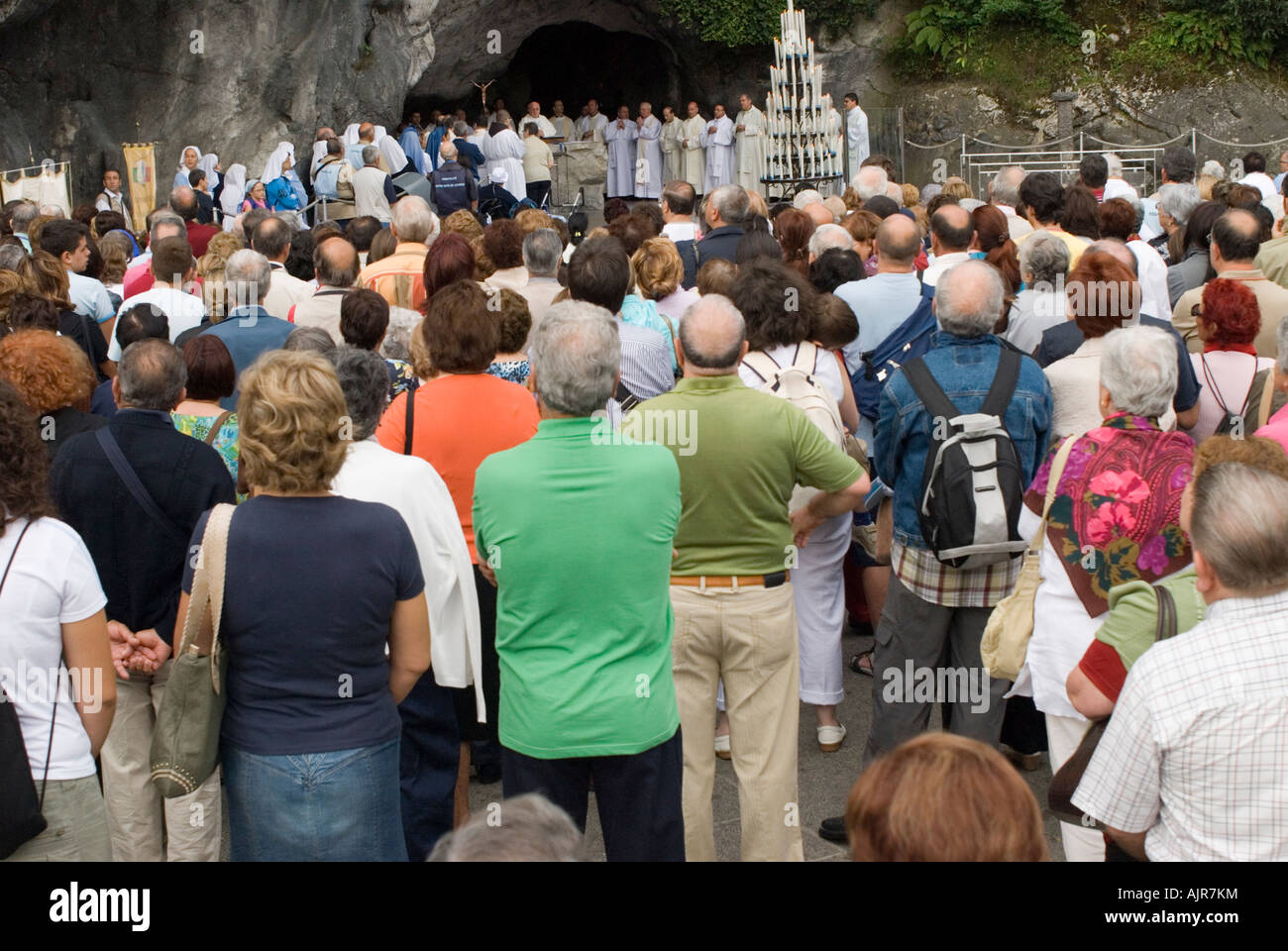Pilgrims praying and getting blessings in front of grotto, Notre Dame ...