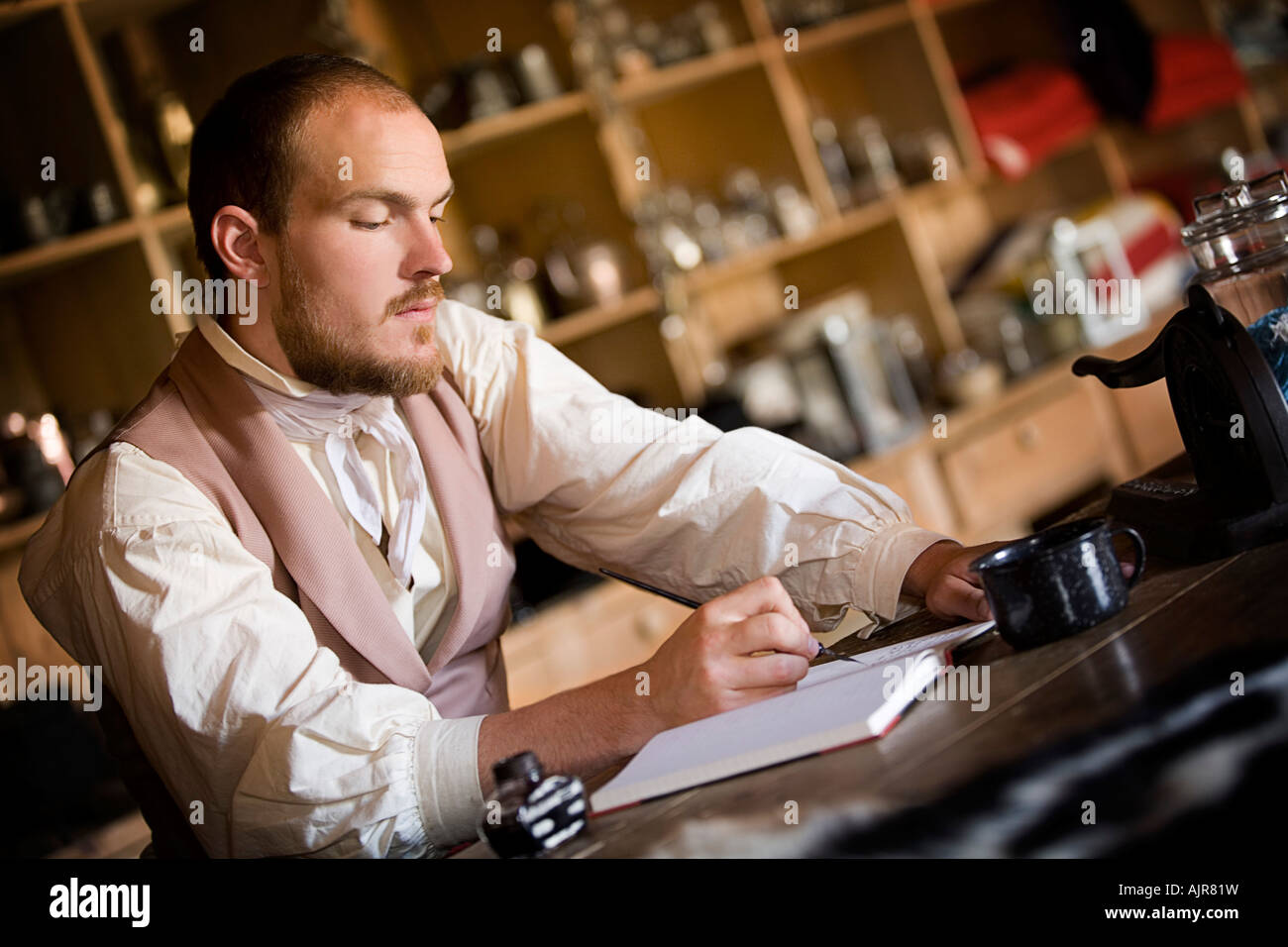 Side view of a man writing notes Stock Photo - Alamy