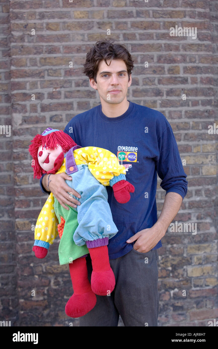 Young Man holding a rag doll Stock Photo - Alamy
