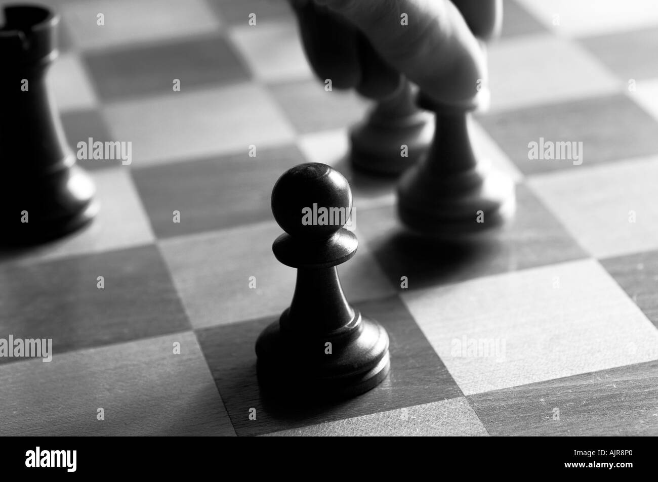 Pawns and rook on a chess board with hand lifting a white pawn Stock ...