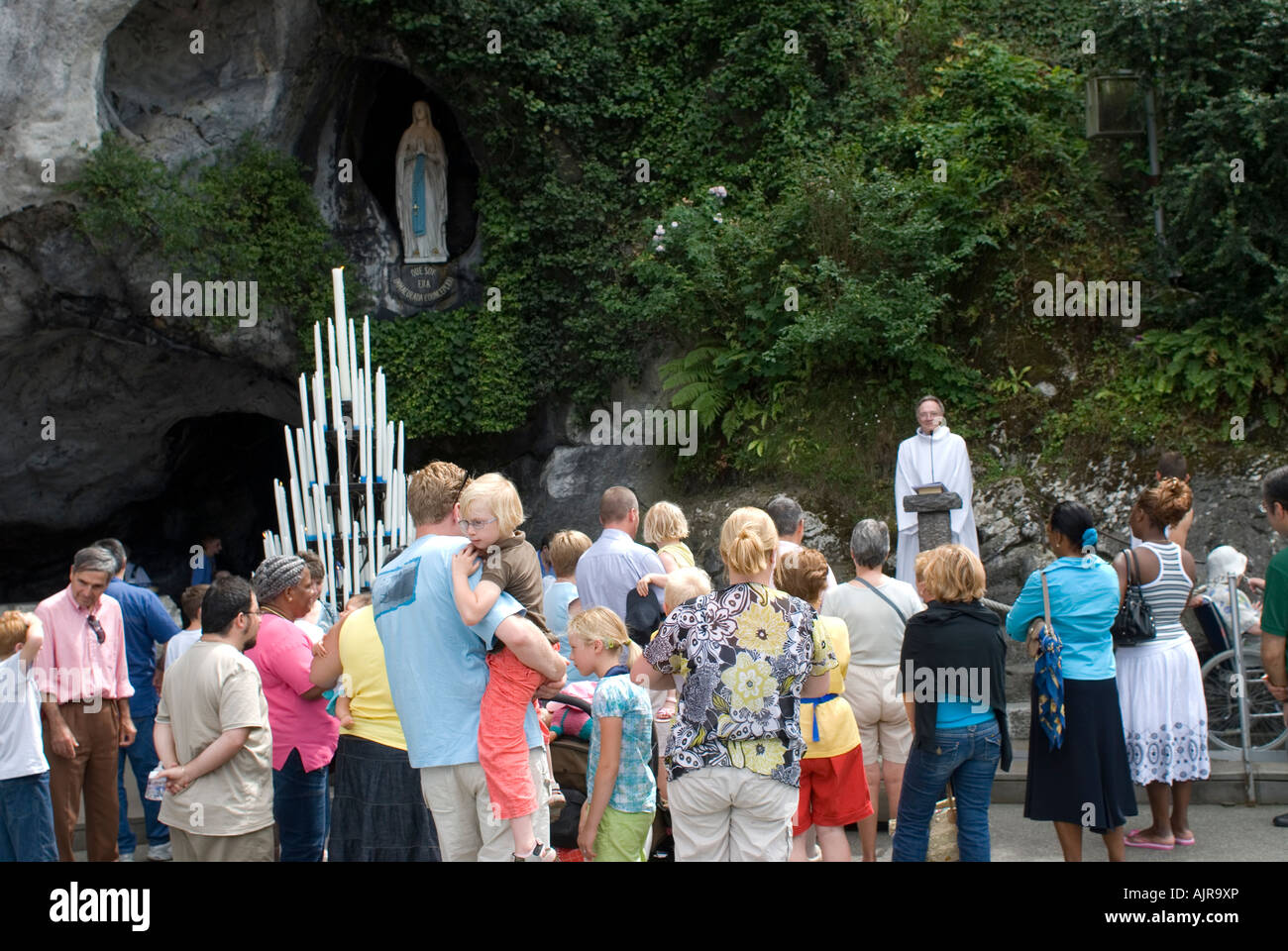 Blessing by priest in front of the grotto Stock Photo - Alamy