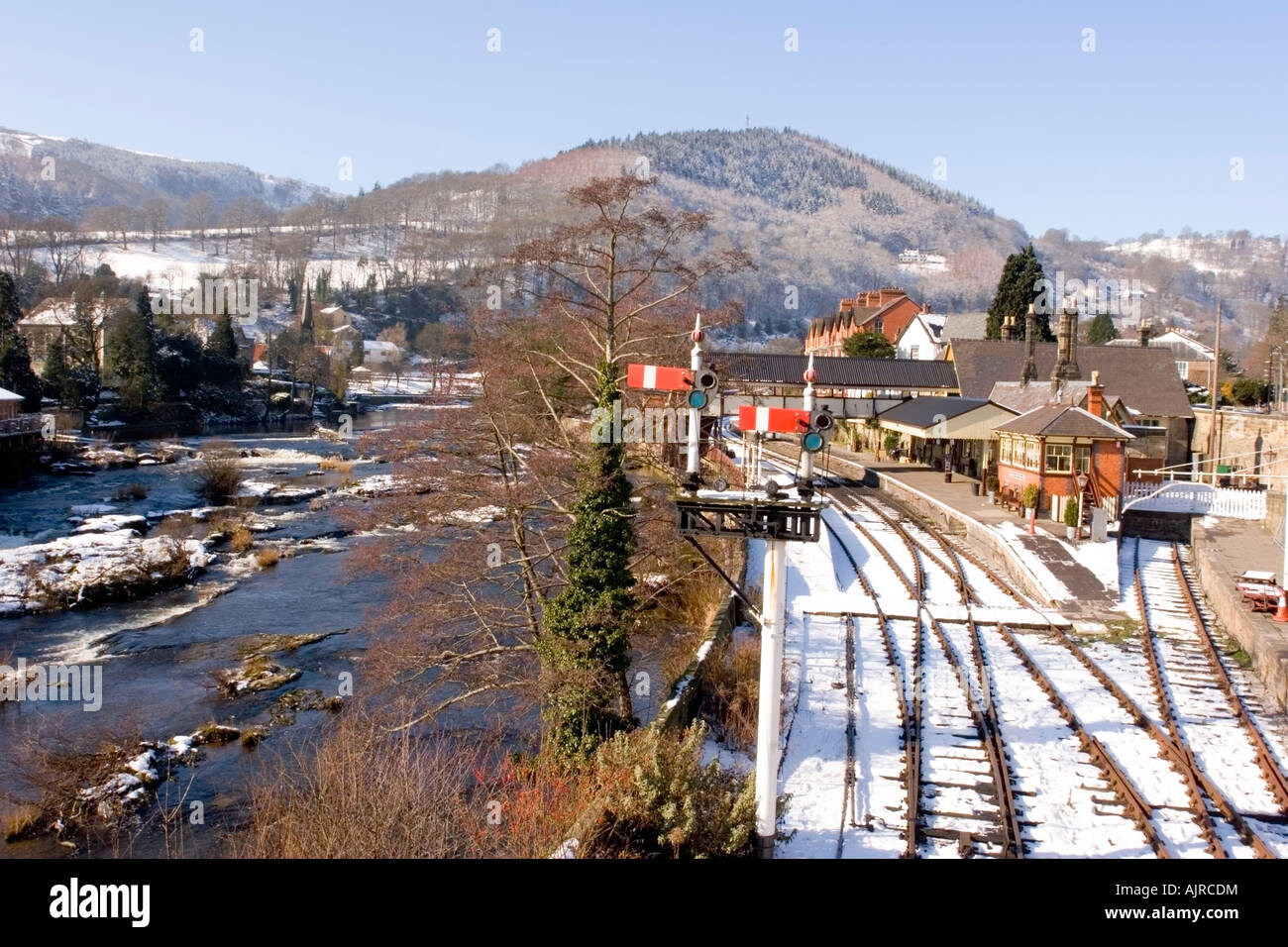 A snowy Llangollen railway station and tracks, along side the River Dee ...