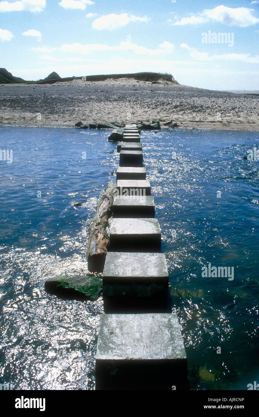 Stepping stones across water Stock Photo - Alamy