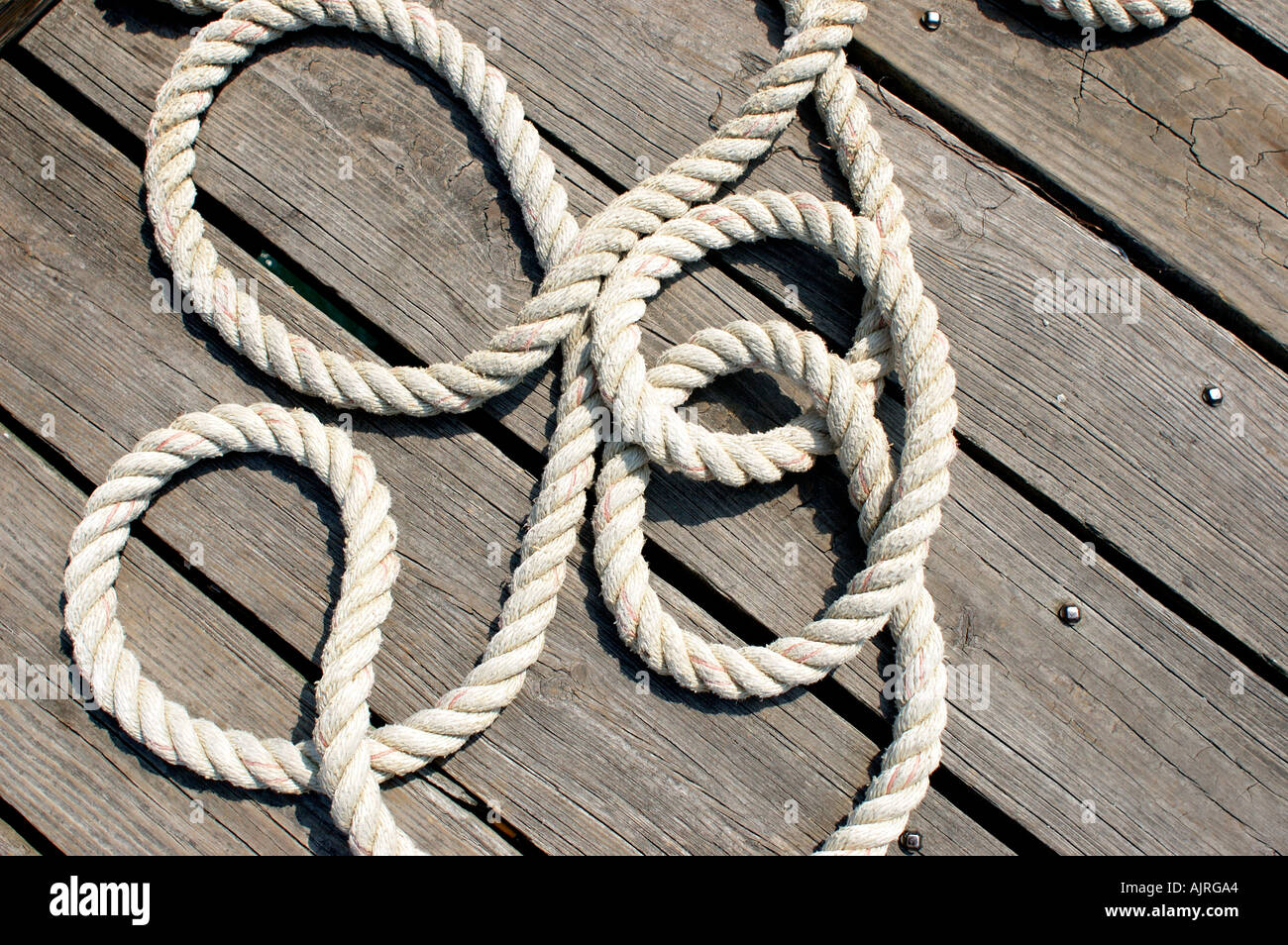 rope twine string braid braided rope twisted loose laying on the ground ...