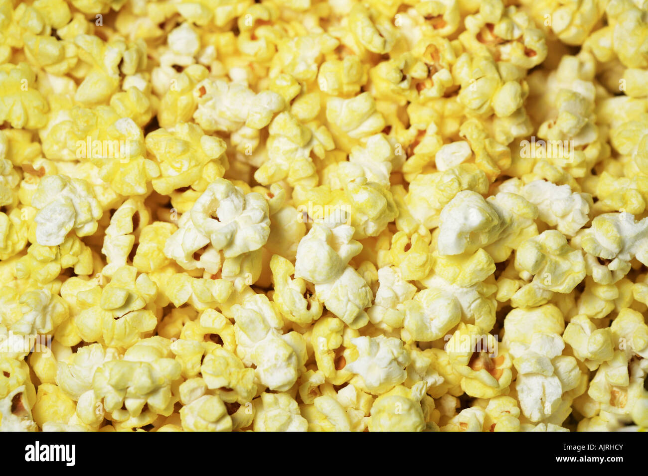 Yellow buttered popcorn background Stock Photo - Alamy