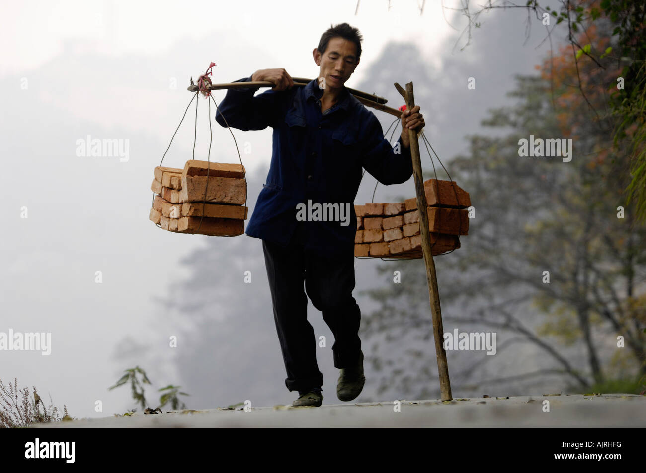 Man carrying bricks hi-res stock photography and images - Alamy