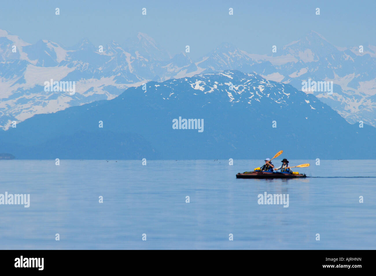 Kayakers in a tandem sea kayak in Glacier Bay National Park and ...