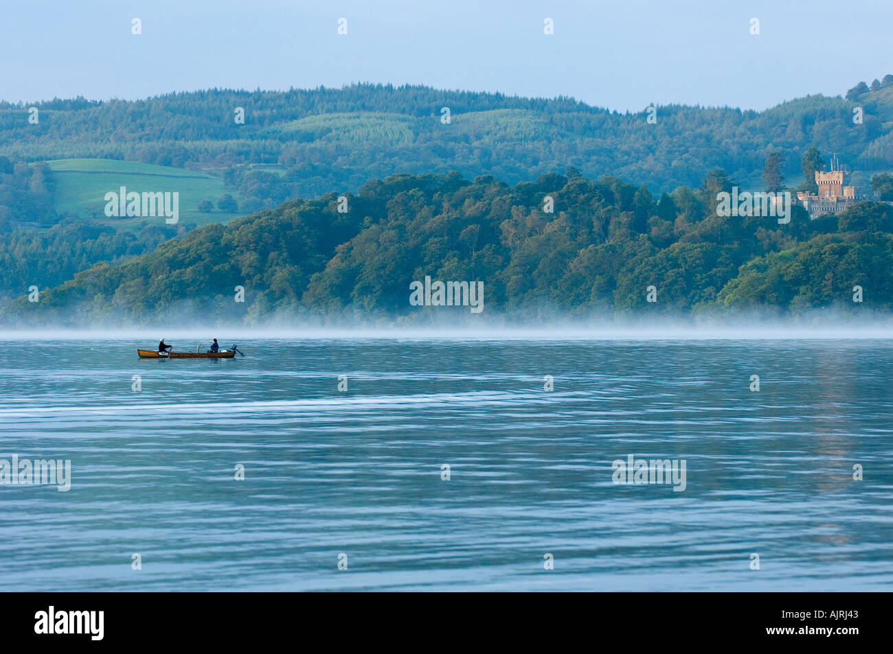 Lake District fishing on Lake Windermere with early morning mist with ...