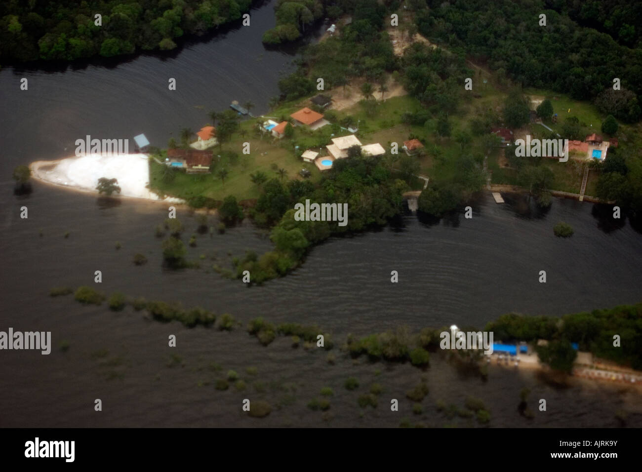 Neighborhood surrounded by flooded tropical rain forest aerial view ...