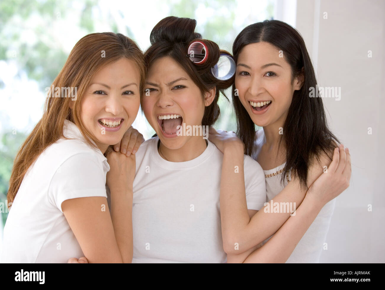Portrait of three young women smiling Stock Photo - Alamy