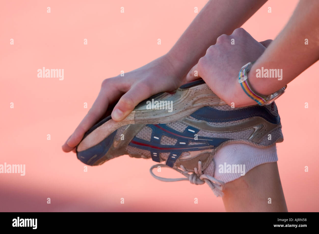 Person putting pressure on the foot of an athlete during a stretching ...