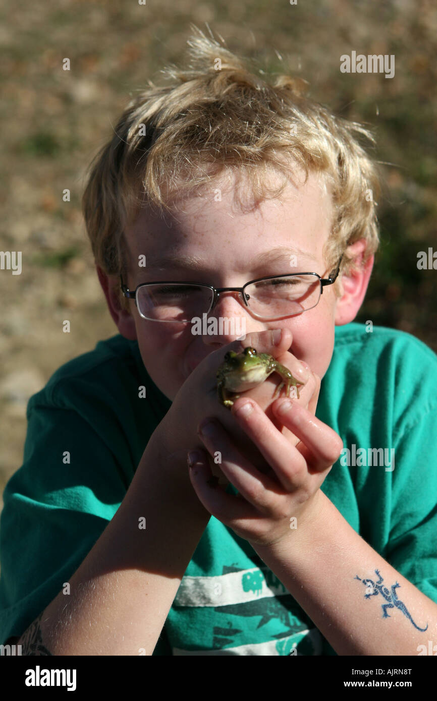 kid holding and playing with a frog Stock Photo - Alamy