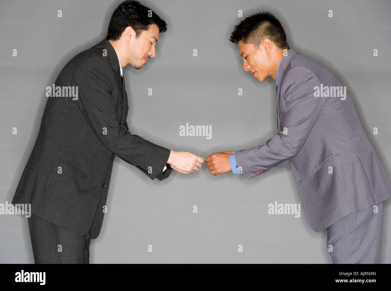 Side profile of two businessmen greeting each other Stock Photo - Alamy