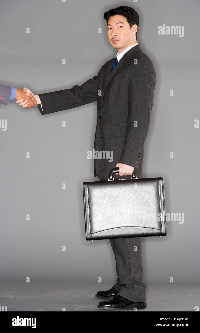 Portrait of businessmen shaking hands Stock Photo - Alamy