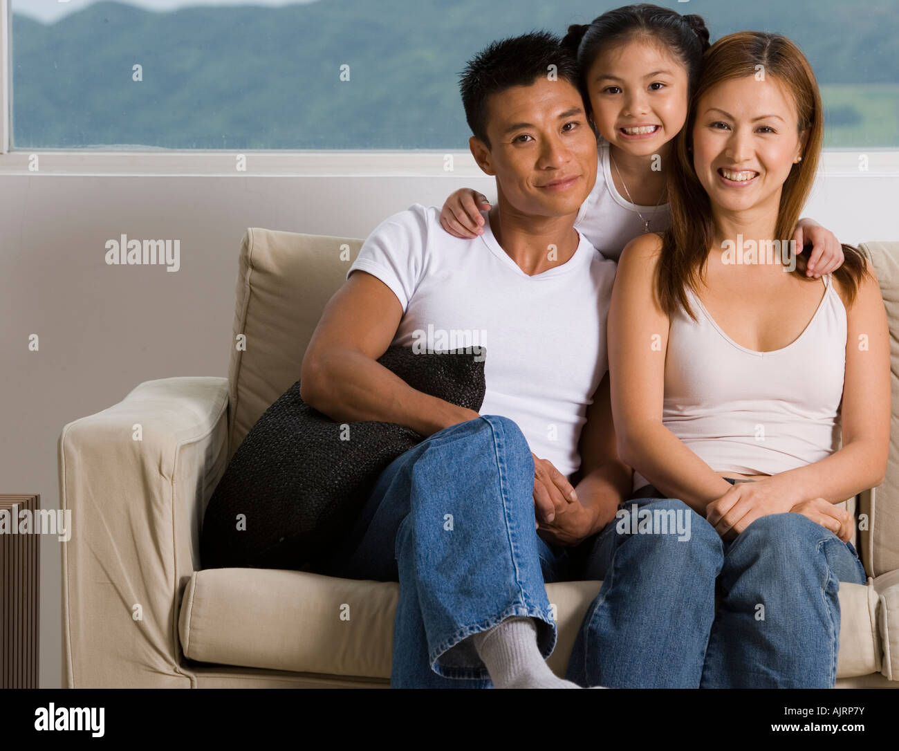 Portrait of a girl and her parents smiling Stock Photo - Alamy