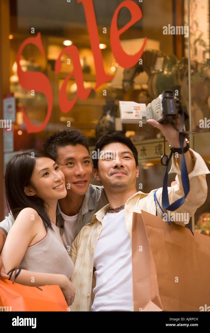 Close-up of three friends looking at a digital camera Stock Photo - Alamy