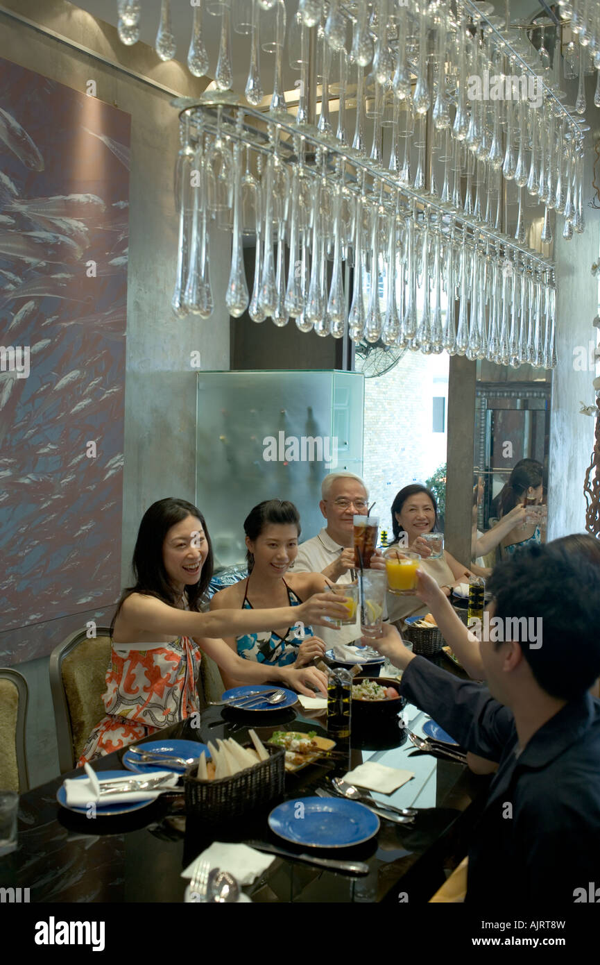 Parents sitting together with their children at the dining table Stock ...