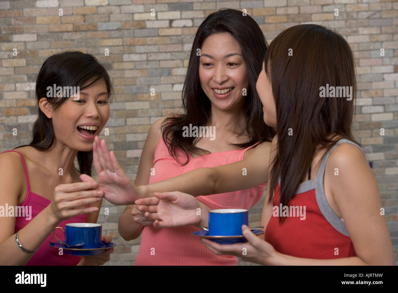 Close-up of a young woman showing her ring to her friends Stock Photo ...